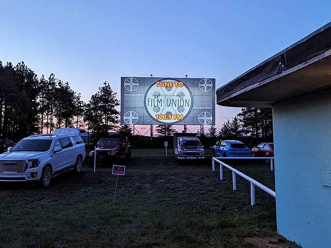 Trucks and SUVs line up on the gravel lot at Highway 2, creating a community atmosphere where Upper Peninsula residents gather for big-screen magic.