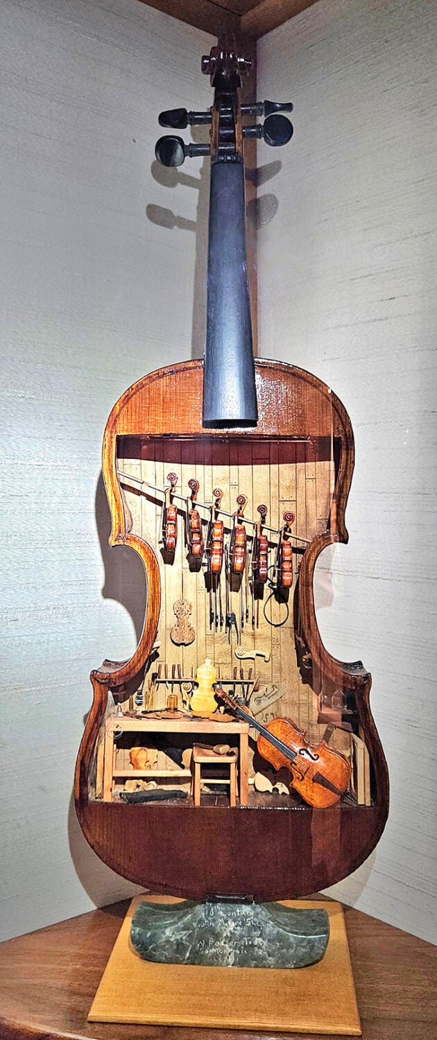 This violin maker's workshop contains tools smaller than eyelashes, with tiny instruments hanging like musical fruit from the ceiling of this thumb-sized 18th-century time capsule.