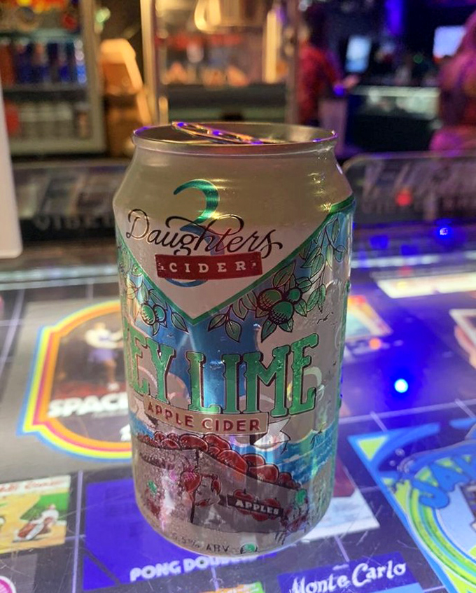 The refreshing 3 Daughters Key Lime Cider offers a taste of Florida between gaming sessions, its bright can as colorful as the arcade lights.
