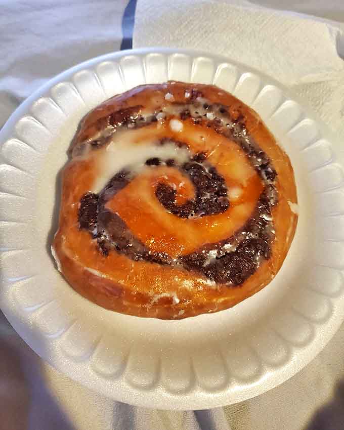This cinnamon roll isn't just breakfast; it's an experience. The perfect spiral of dough, cinnamon, and glaze creates a morning masterpiece.