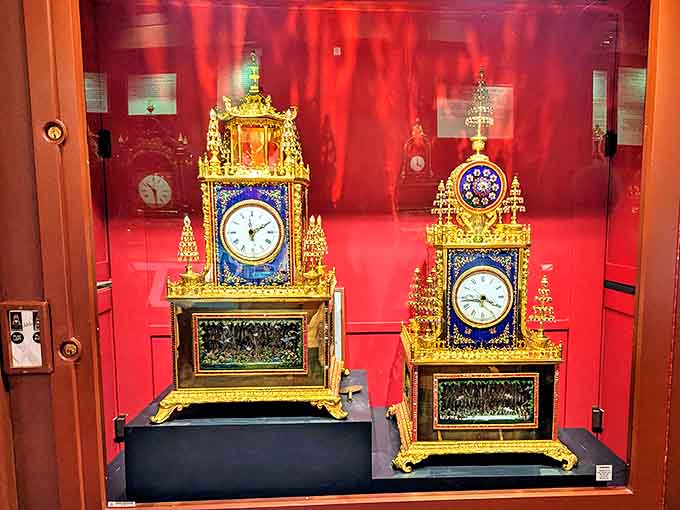 Ornate European clocks stand like golden sentinels in their crimson chamber, their faces revealing the artistry that went into marking each precious minute.