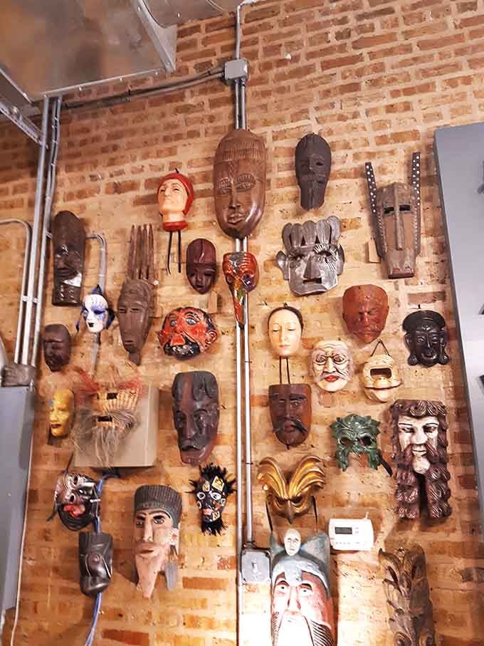 The mask wall watches your every move with silent judgment. That wooden fellow in the middle has definitely seen things.