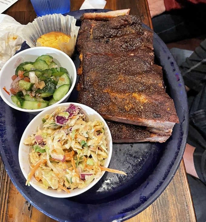 The holy trinity of barbecue bliss: tender ribs, creamy slaw, and that cucumber salad providing the perfect palate refresh.
