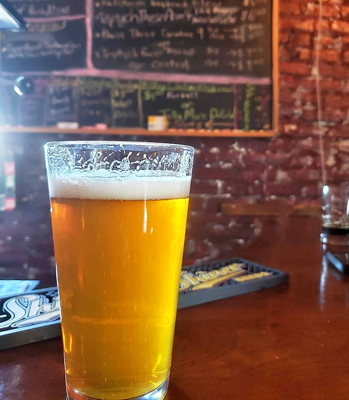 Golden, hazy, and perfectly poured, this beer catches the light like liquid sunshine in a glass, ready for its close-up.