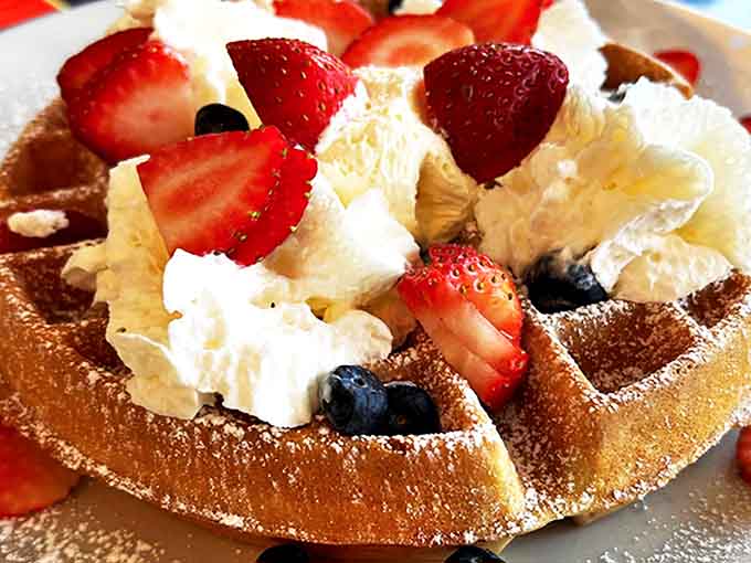 Berry-topped Belgian waffle crowned with whipped cream &ndash; a breakfast that straddles the line between meal and dessert beautifully.