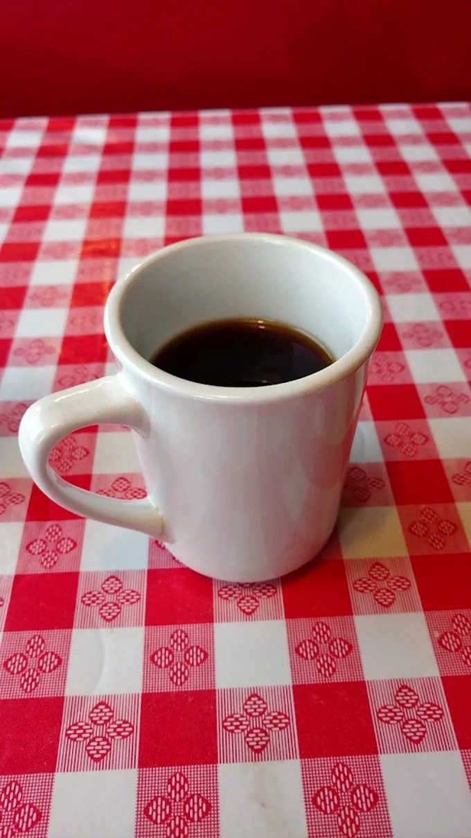 Simple pleasures: A sturdy mug of honest-to-goodness coffee on a classic red and white checked tablecloth &ndash; no foam art required.