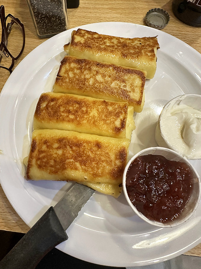These golden blintzes are delicate crepes wrapped around sweetened farmer's cheese, pan-fried to perfection and waiting for their fruit compote companion.