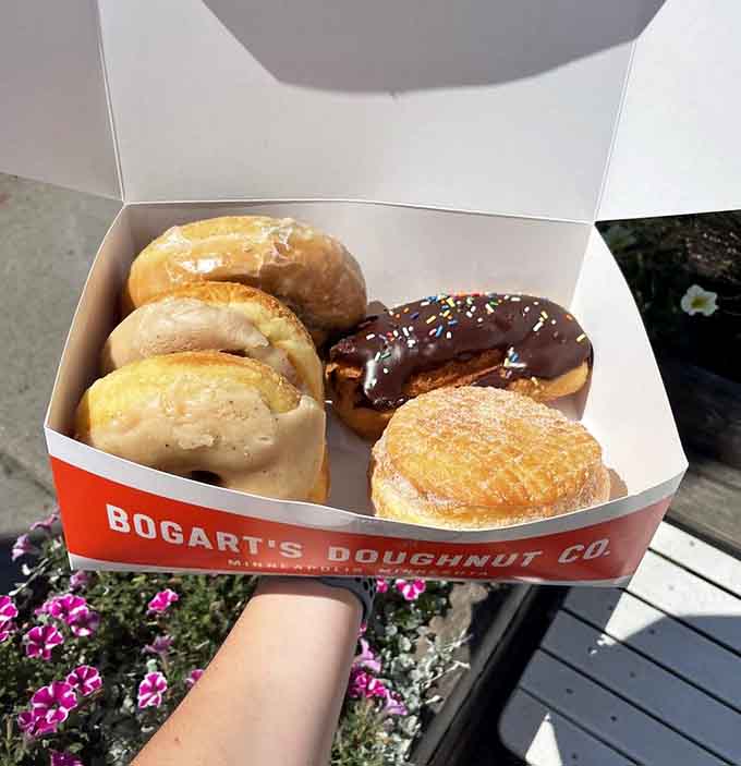 A box full of glazed, chocolate, and sugar-dusted happiness that's basically a hug you can eat.