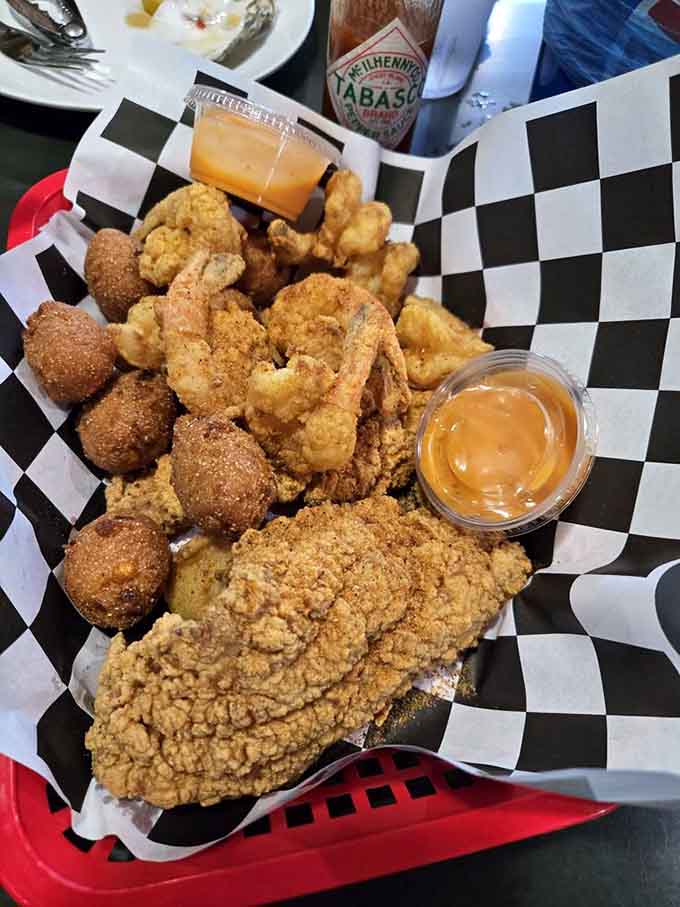 Golden fried perfection: catfish, shrimp, and hush puppies that prove this place does more than just boils.