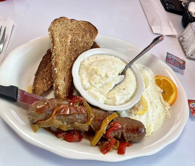 The perfect marriage of snap and sizzle &ndash; juicy bratwurst alongside fluffy eggs and creamy Southern grits.