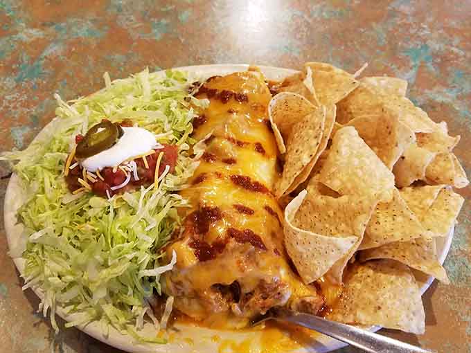 That golden cheese blanket covering tender enchiladas is basically edible happiness in plate form.