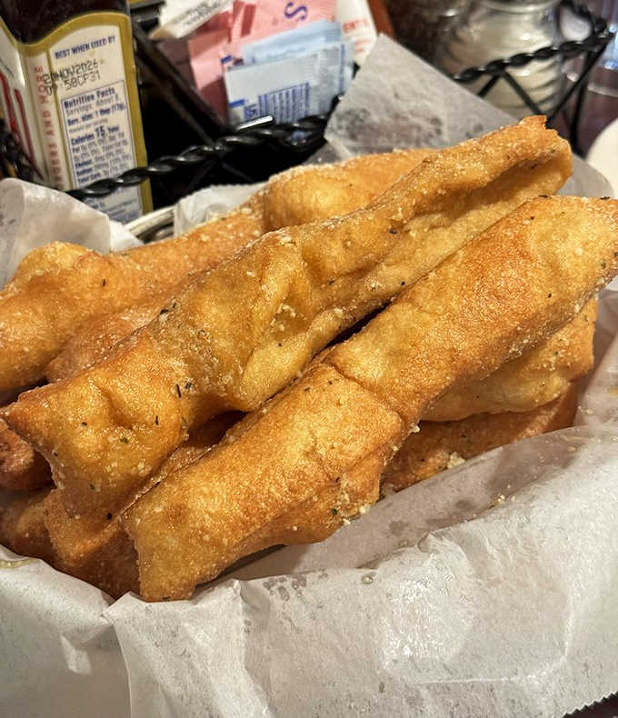 Golden-brown breadsticks glisten with a kiss of butter, waiting to be dunked, dipped, or devoured between courses.