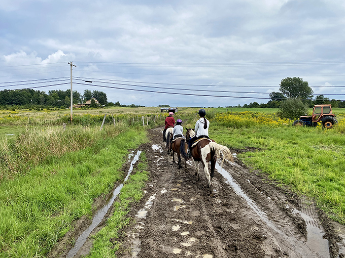 Horseback riders explore Grand Isle's muddy back roads, where getting dirty is half the fun of country exploration.