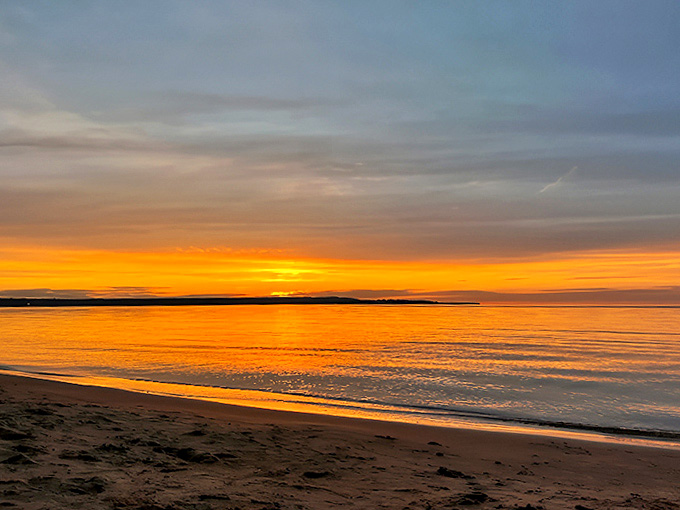 Lake Superior's legendary sunset paints the sky in impossible oranges and pinks, a nightly show that never fails to silence conversations.