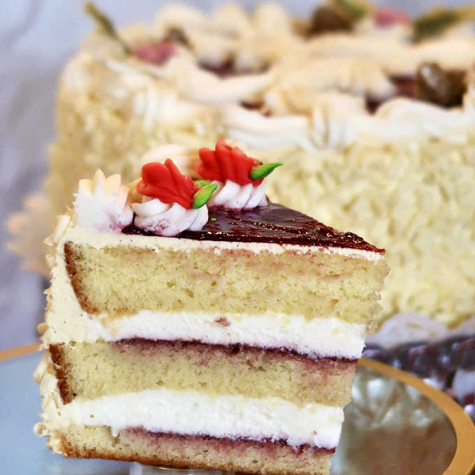 Layers of delicate cake with what appears to be raspberry filling create a torte that's both a feast for the eyes and palate.