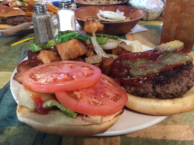 A burger that requires strategy to eat &ndash; note the perfectly melted cheese, fresh vegetables, and a bun somehow engineered to contain this beautiful mess.