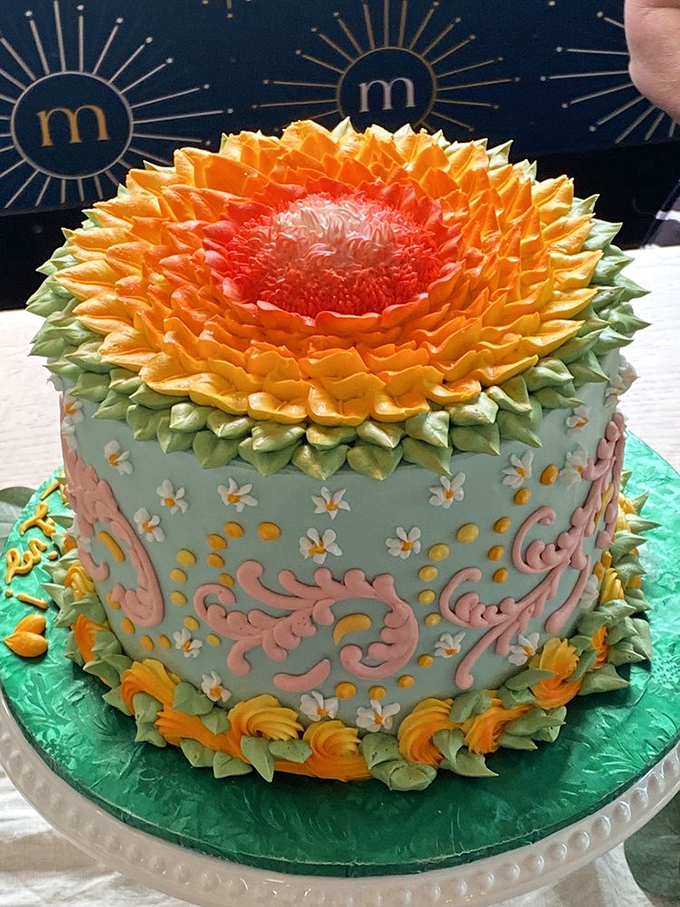 A buttercream sunflower cake that belongs in an art gallery, with gradient-colored petals so meticulously crafted you'll hesitate before cutting the first slice.
