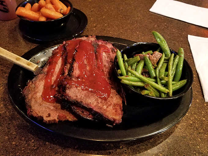 Perfectly smoked brisket with that coveted pink smoke ring, accompanied by green beans that actually deserve space on your fork.