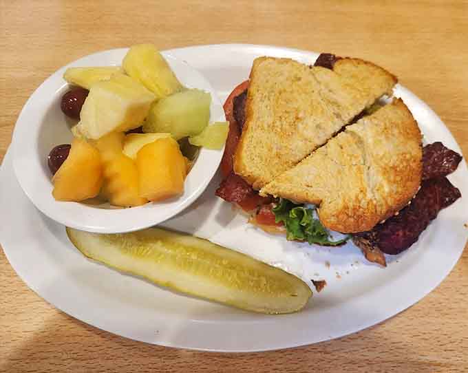 This BLT situation comes with fruit salad because apparently someone here believes in balance, bless them for that thoughtfulness.