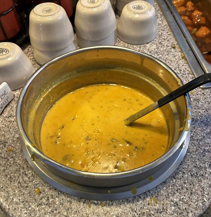 Kelly's legendary cheese soup glows with a rich golden hue, promising velvety comfort in every spoonful of this closely guarded secret recipe.