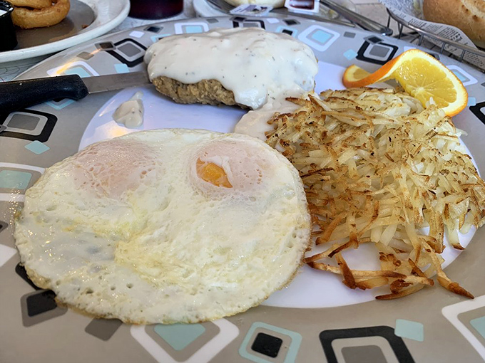 The holy trinity of diner perfection&mdash;crispy-edged steak, golden hash browns, and an egg waiting to unleash its liquid gold.