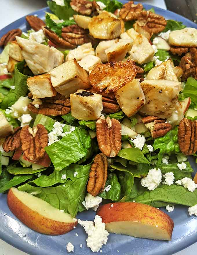 Fresh greens, crunchy pecans, and grilled chicken come together in a salad that's far more interesting than typical restaurant fare.