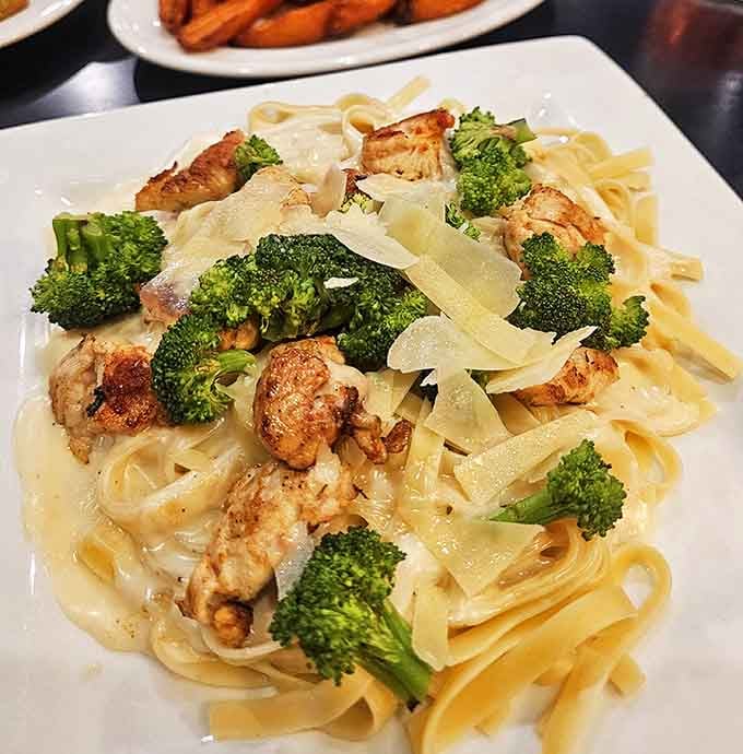 Fettuccine Alfredo cradles tender chicken and bright broccoli in a creamy embrace &ndash; comfort food that hugs you from the inside out.