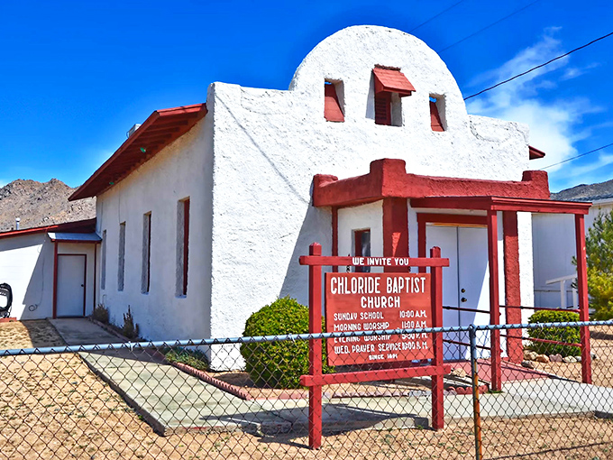The whitewashed Chloride Baptist Church has been welcoming worshippers since 1918, its red trim and mission-style architecture a testament to frontier faith.