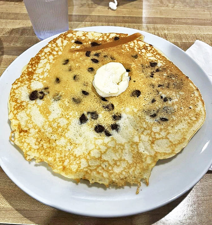 A chocolate chip pancake so perfect it deserves its own Instagram account. That dollop of butter is basically saying, "You're welcome."