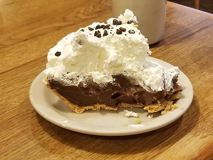 A chocolate cream pie so decadent it should require a permission slip – that whipped cream mountain isn't just for show.