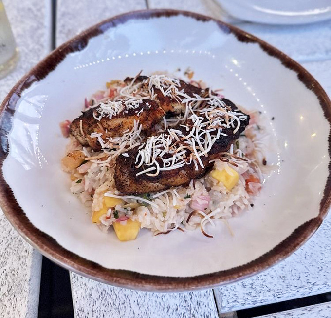 Coconut-crusted grouper rests on a bed of tropical rice&mdash;Florida sunshine transformed into an edible masterpiece.