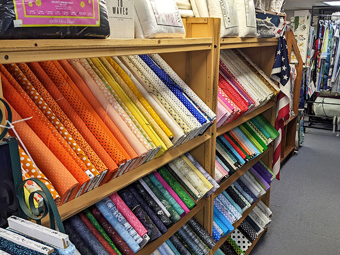 Fabric bolts arranged by color create an Instagram-worthy rainbow that makes choosing just one nearly impossible.