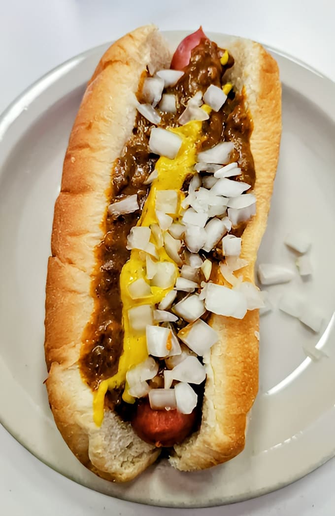 The legendary Detroit Coney Dog in all its glory &ndash; a perfectly steamed beef frank, secret-recipe chili, diced onions, and yellow mustard creating a symphony of flavors.