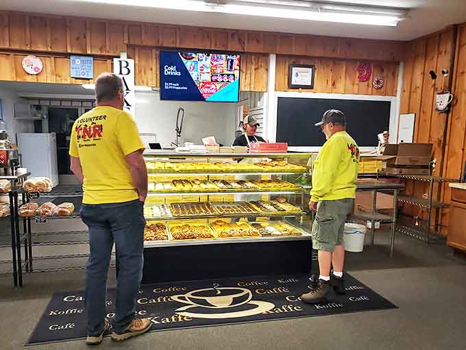 The moment of truth approaches as customers in bright volunteer shirts contemplate which sugary masterpieces will make the final cut.