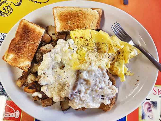 Country Fried Steak and Sides: A masterclass in comfort food &ndash; crispy, savory steak smothered in gravy alongside perfect breakfast companions.