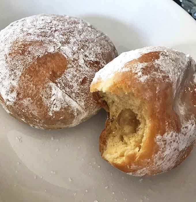 Cream-filled and apple cider donuts dusted with powdered sugar, because sometimes simple perfection needs no explanation.