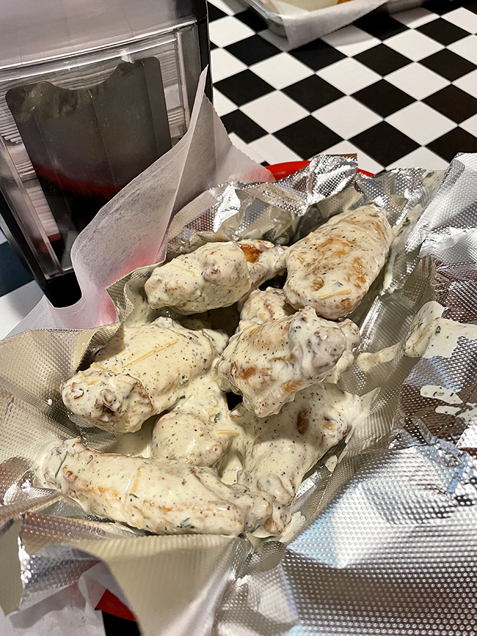 Garlic parmesan wings that'll make you temporarily forget your table manners. That creamy coating contains enough flavor to make grown adults lick their fingers shamelessly.
