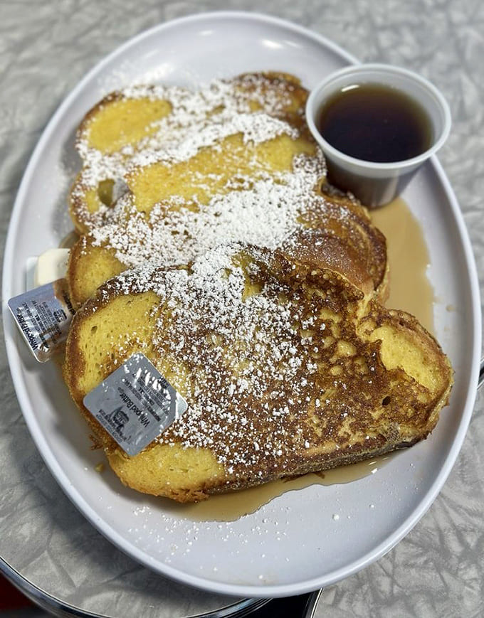 French toast this thick and golden could make you forget about pancakes forever, dusted with powdered sugar like edible snow.