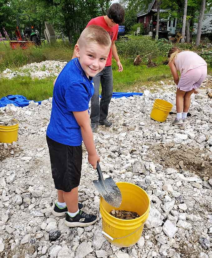 Young prospectors learning that the best treasures require getting your hands dirty and your knees dusty, life lessons disguised as fun.