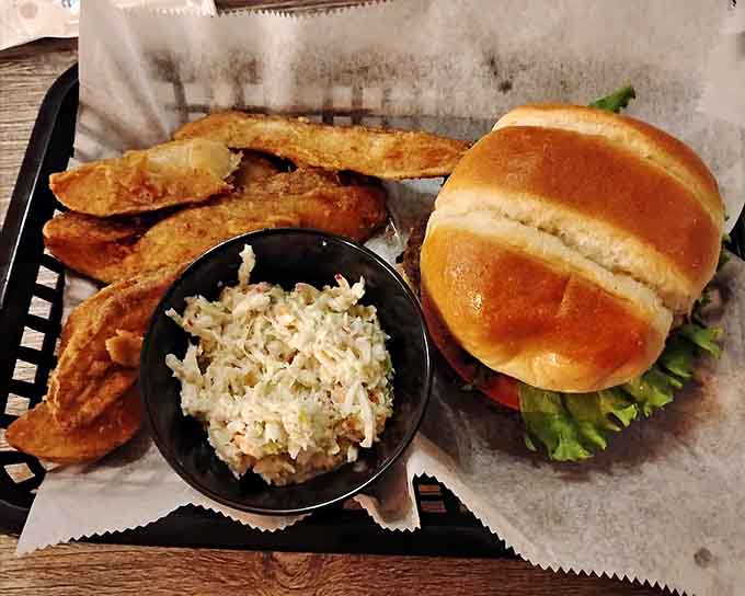 This burger comes with coleslaw and enough fries to make you forget about your afternoon plans entirely.
