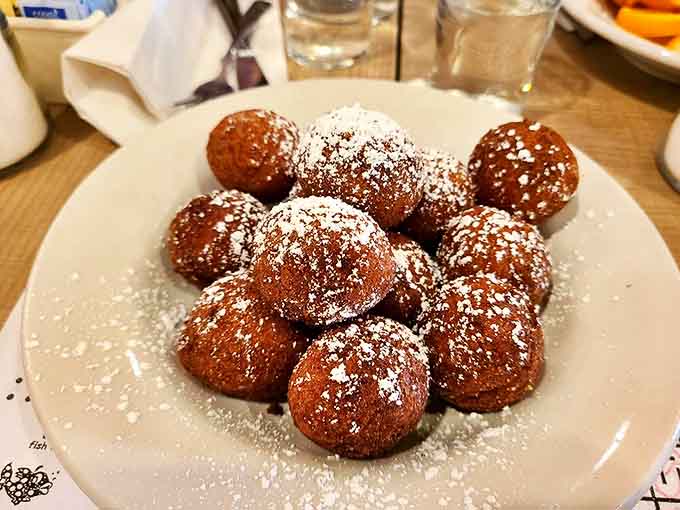 Warm donut holes dusted with powdered sugar greet every guest, setting a sweet tone before the main event even begins.