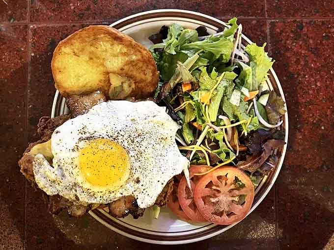 A perfectly crafted sandwich awaits, with golden toast framing layers of deliciousness and those hand-cut fries standing by for sauce-scooping duty.