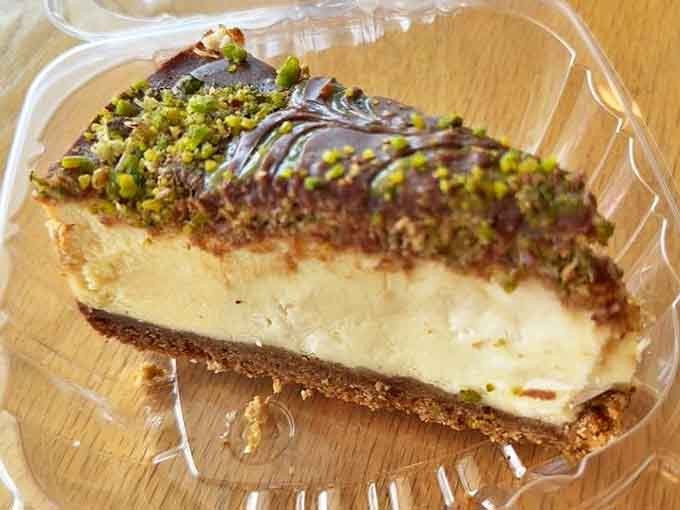 Dubai Kunafa Cheesecake topped with crispy orange shreds and pistachios – where Middle Eastern tradition meets Western indulgence in perfect harmony.