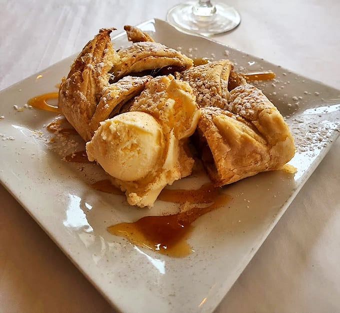 Sweet surrender comes in the form of this warm apple strudel, where flaky pastry meets vanilla ice cream in a dessert worth saving room for.