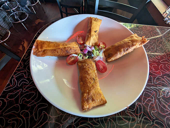 Golden-brown perfection arranged in a cross formation, these crispy vessels deliver a satisfying crunch before revealing their savory treasures.