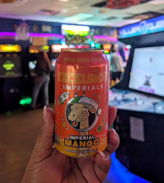 The vibrant Excelsior Imperial Mango can pops against the arcade's glow, offering tropical notes to complement your digital adventures.