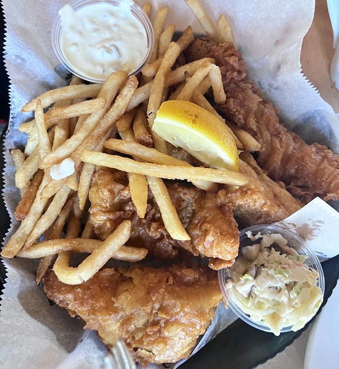 Golden-battered fish and crispy fries arrive hot and fresh – a testament to the kitchen's mastery of this Great Lakes classic.