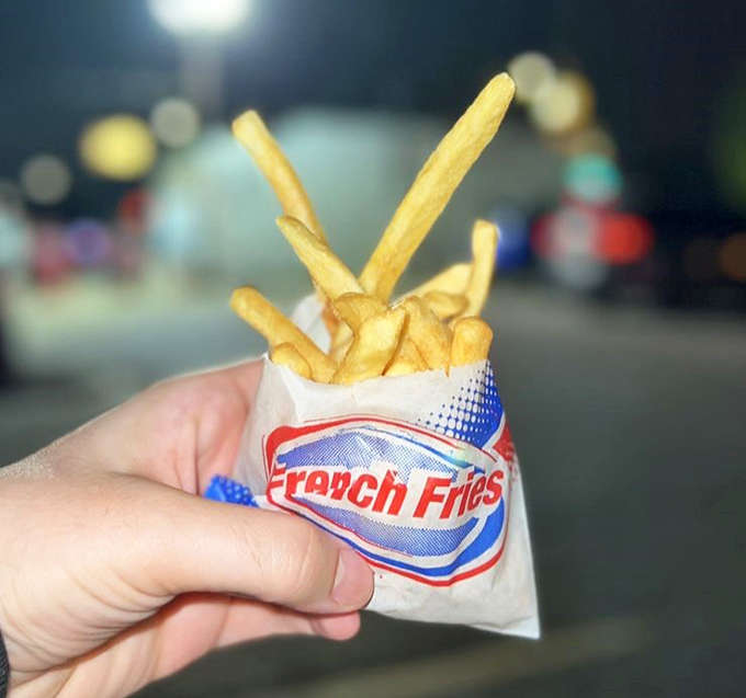 Golden fries standing tall in their paper sleeve &ndash; the perfect supporting act to any Telway burger performance.