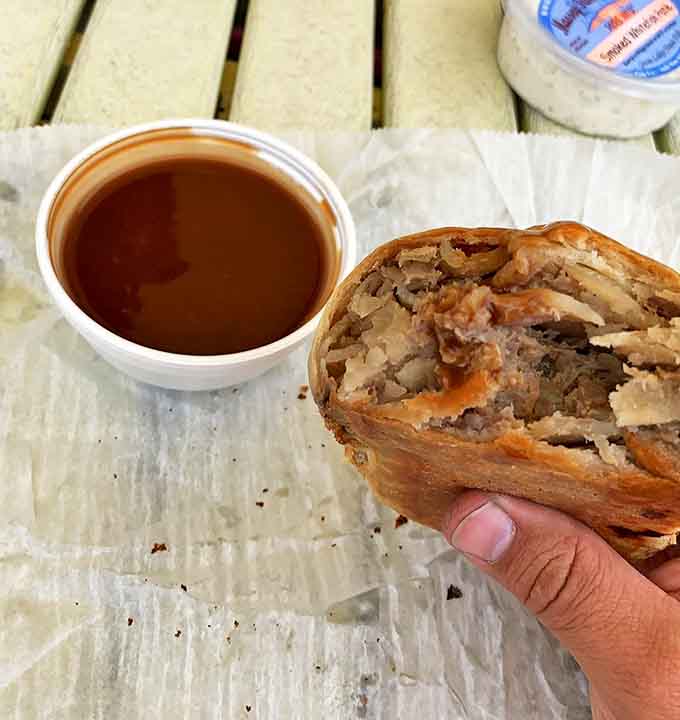 A cross-section reveals the perfect ratio of filling to crust &ndash; tender meat and vegetables encased in flaky pastry that's been perfected over generations.