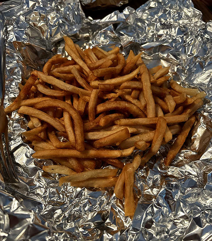 Golden, crispy french fries nestled in foil &ndash; the ideal vehicle for sopping up every last drop of that legendary sauce.